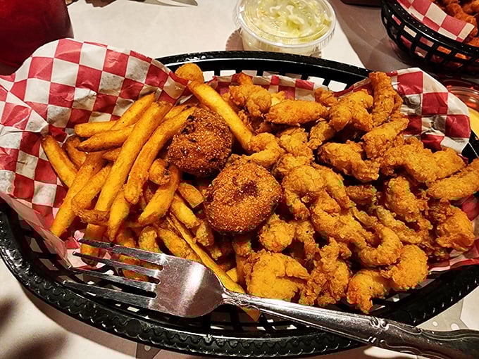 Golden-fried shrimp and hushpuppies nestled beside crispy fries—proof that sometimes the simplest pleasures deliver the most satisfaction.