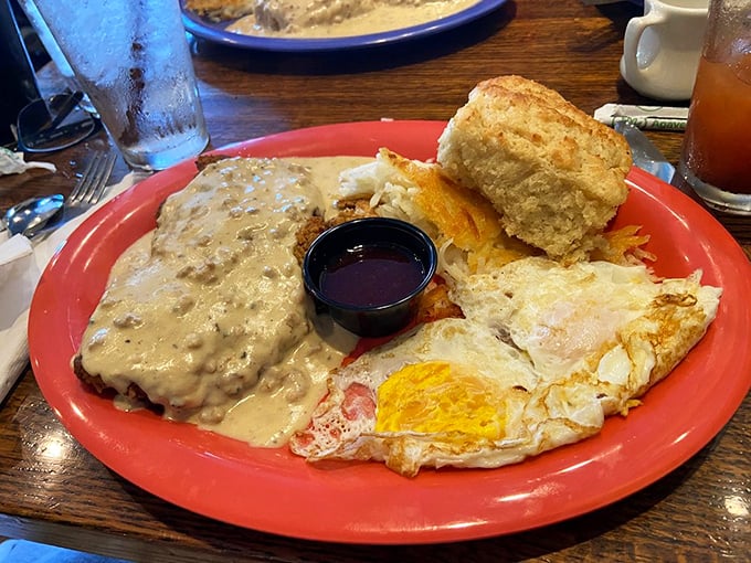 Chicken fried steak smothered in gravy alongside perfectly cooked eggs – this is Kansas comfort on a plate.