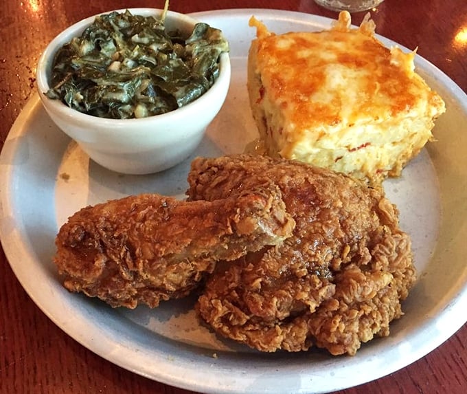 Golden-brown chicken that shatters at first bite, paired with collards and mac and cheese custard—a holy trinity of Southern cooking if ever there was one. 