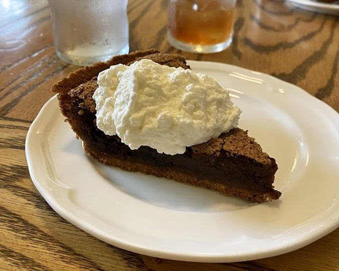 The legendary fudge pie that launched a thousand road trips. Half brownie, half heaven, topped with whipped cream that doesn't come from any can.