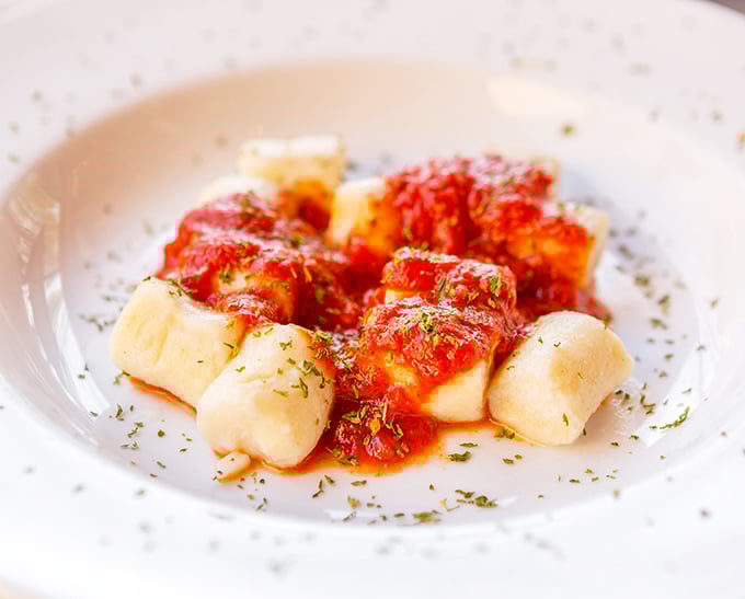 These pillowy gnocchi aren't just pasta—they're little clouds of potato perfection swimming in bright marinara sauce that would make any Italian grandmother nod in approval.