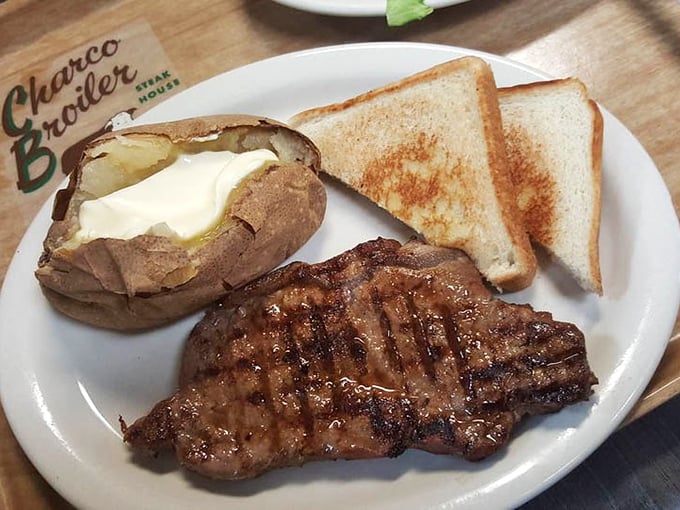 This is what dreams are made of—a perfectly charred steak, butter-drenched potato, and toast ready for juice-sopping duty.