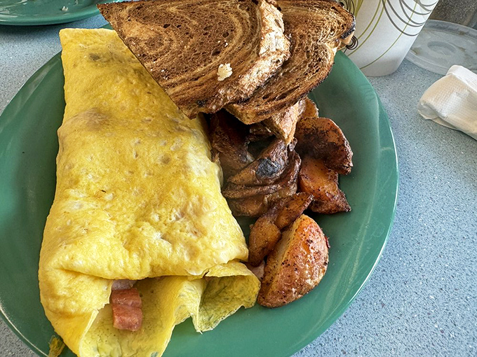 This ham-stuffed omelet is what breakfast dreams are made of. Perfectly executed, generously filled, and paired with home fries that could make a potato farmer weep with joy.