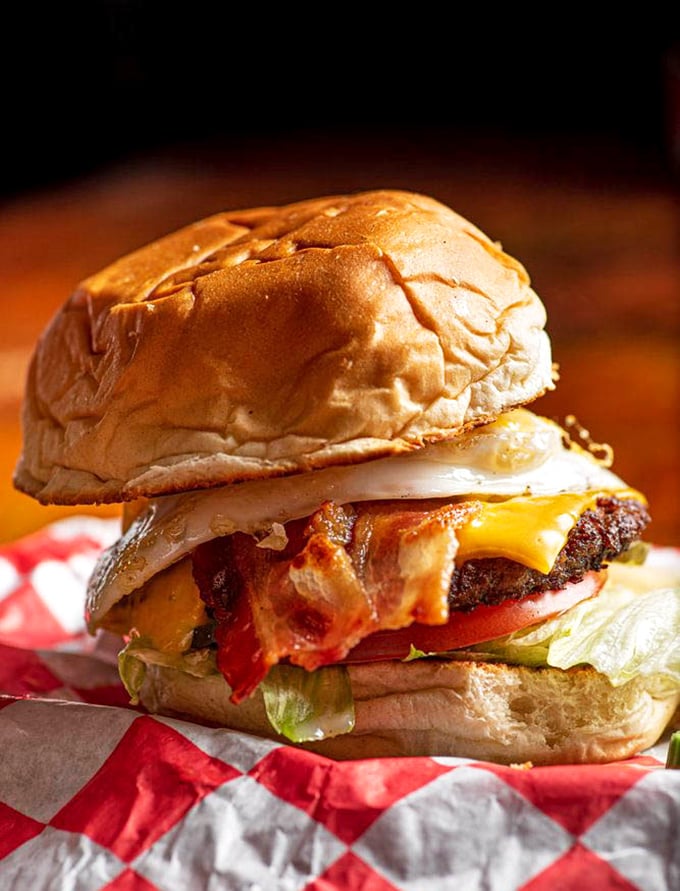 This isn't just a burger – it's a masterpiece of architecture where bacon, egg, and cheese create the holy trinity of hangover remedies.