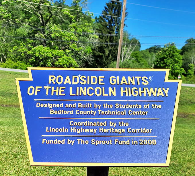 The blue historical marker reveals this metallic marvel was crafted by Bedford County Technical Center students—proving education really does pay.