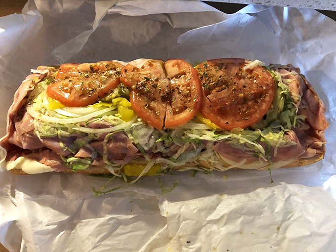 Behold the Italian hoagie in its natural habitat – a perfect ratio of meat, cheese, and veggies that makes mathematicians weep.