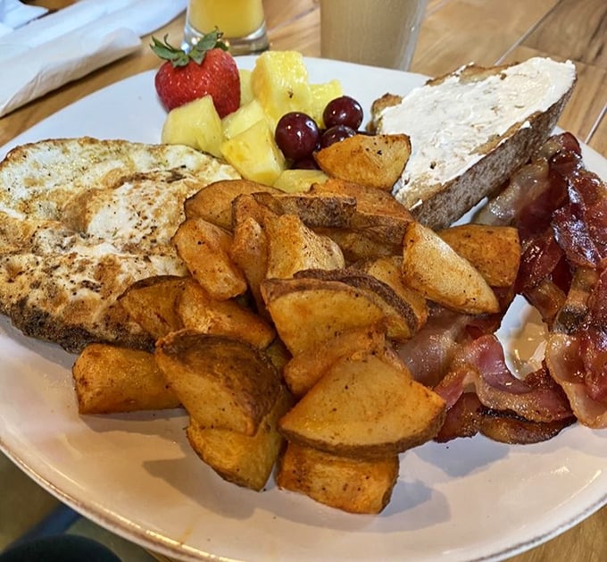 Breakfast perfection doesn't exi— Oh wait, it does. Golden potatoes, crispy bacon, and fresh fruit create the holy trinity of morning satisfaction.