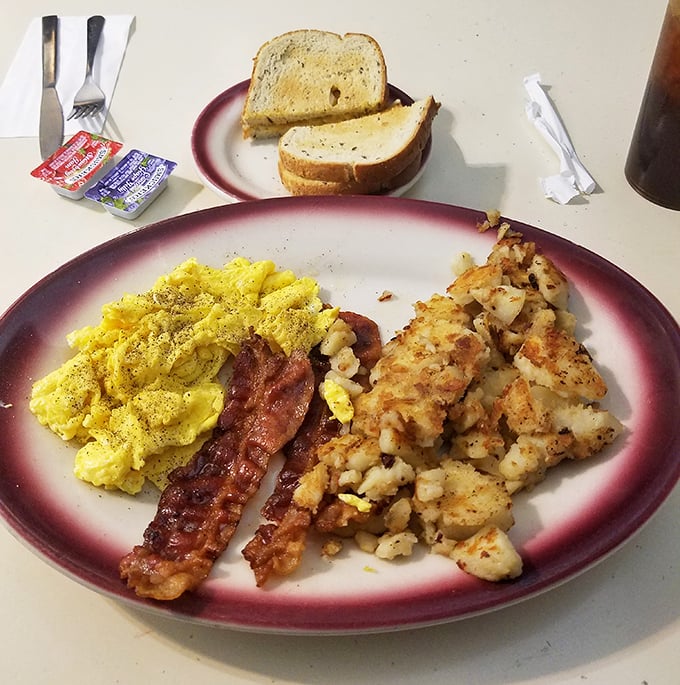 Breakfast perfection doesn't need filters—just eggs scrambled to fluffy heights, bacon with the ideal crisp-to-chew ratio, and hash browns worth fighting over.