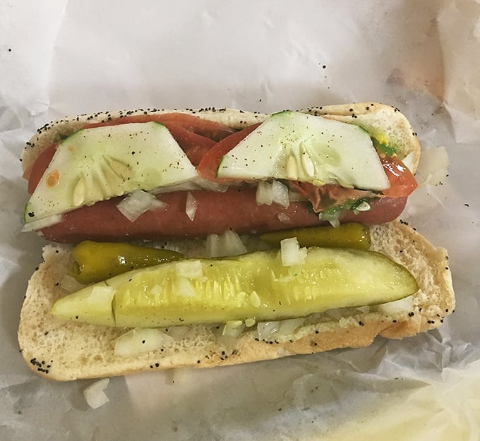 This isn't just a hot dog—it's Chicago on a bun. The pickle spear stands at attention like a guardian of proper hot dog etiquette.