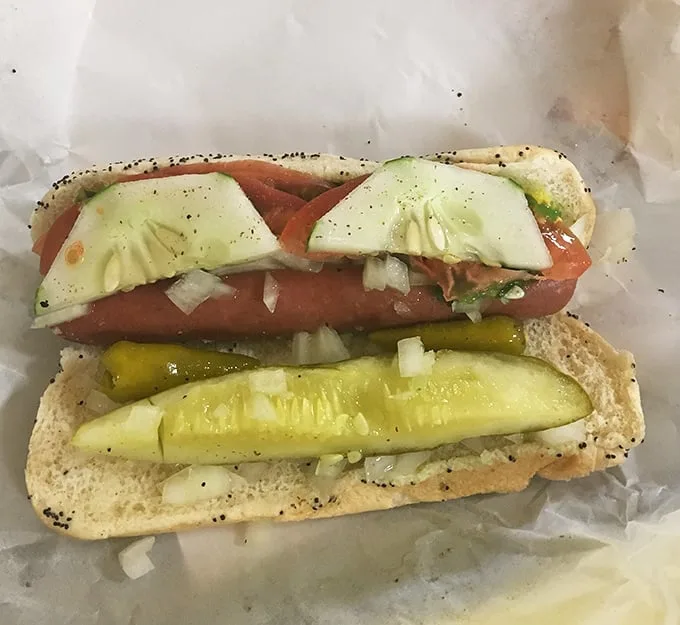This isn't just a hot dog—it's Chicago on a bun. The pickle spear stands at attention like a guardian of proper hot dog etiquette.