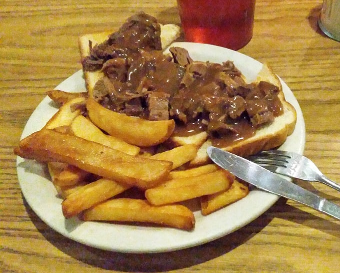 Behold the star attraction—tender roast beef smothered in rich gravy on Texas toast with golden fries. This isn't just a sandwich; it's edible nostalgia.