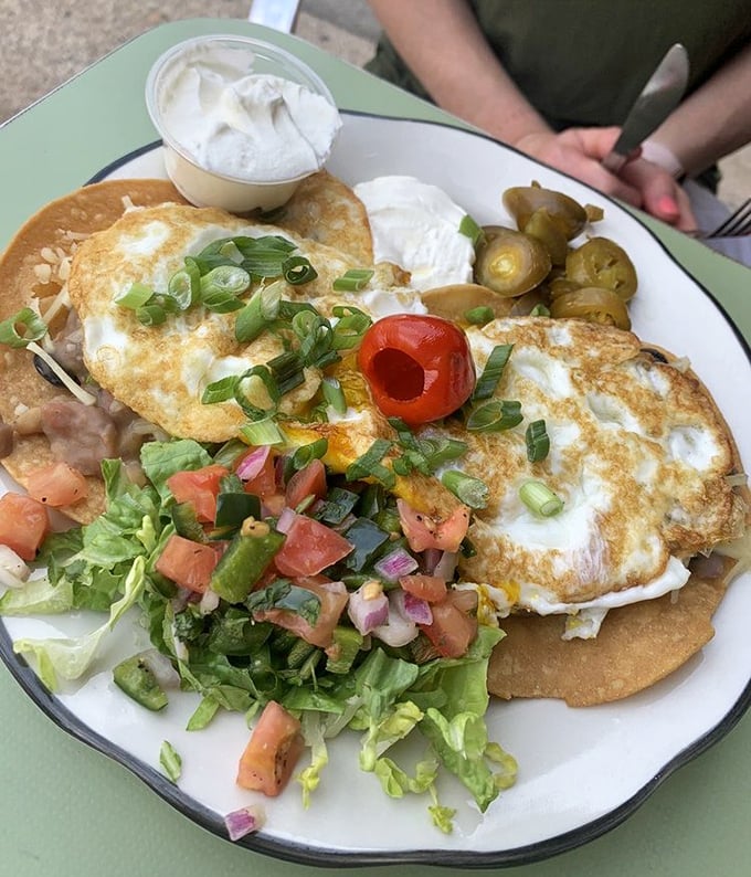 Huevos Rancheros: where tortillas meet eggs in perfect harmony. Fresh pico, creamy sides, and pickled jalapeños create a breakfast symphony.