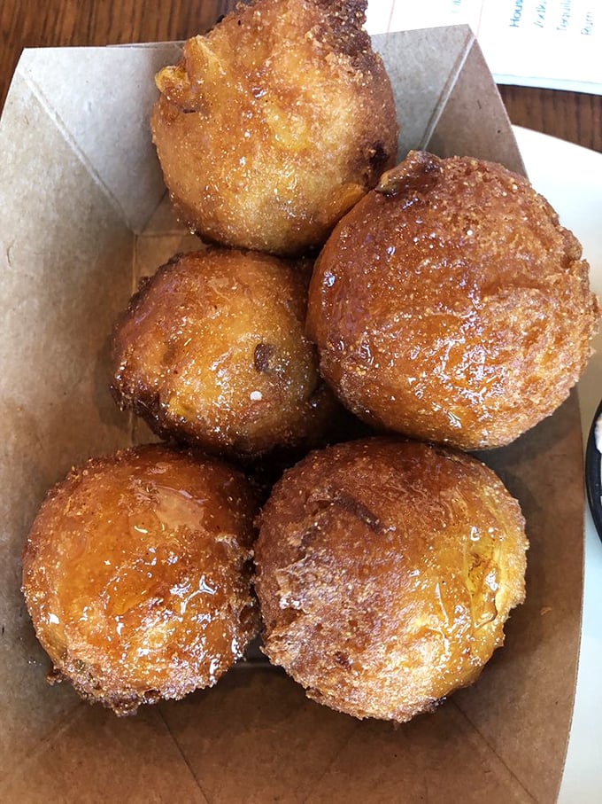 Golden-brown hush puppies that could make a Southerner weep with joy—crispy exterior giving way to a pillowy cornmeal center.