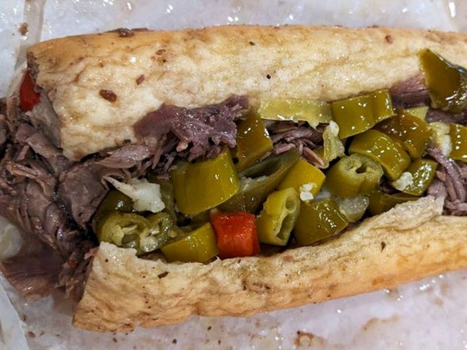 Behold the star of the show—thinly sliced beef, perfectly seasoned, with that hot giardiniera adding just enough kick to make your eyes water with joy.
