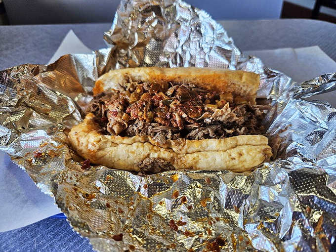 Behold the star of the show: a classic Italian beef sandwich, with thinly sliced beef nestled in the perfect roll, ready for its close-up before disappearing forever.