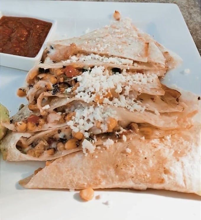 The Jalisco Shrimp Quesadilla arrives like a well-dressed celebrity—golden-crisp exterior, perfectly melted interior, and topped with a sprinkle of cotija that steals the show.