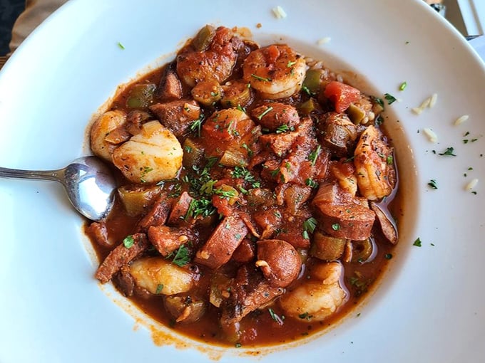 The legendary jambalaya that launched a thousand road trips. Plump shrimp, smoky sausage, and tender chicken swimming in a sauce worth bottling and taking home.