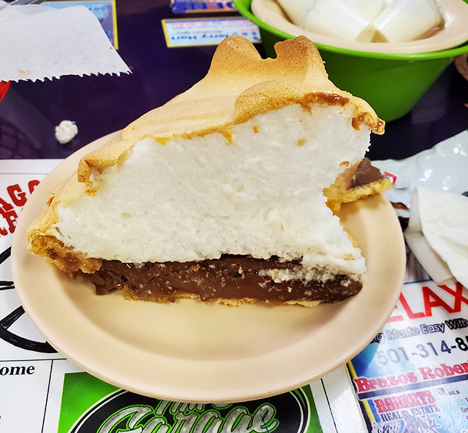 That towering meringue isn't just decoration—it's edible architecture crowning the most legendary key lime pie in the state.