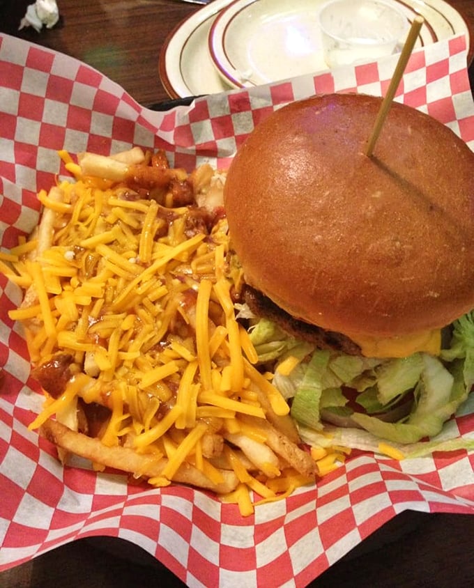 Behold the burger that launched a thousand napkins. The cheese-covered fries aren't a side dish—they're a co-star.