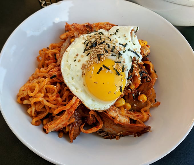 These Korean Fire Noodles don't just sit on your plate—they perform. The sunny-side-up egg crowns a mountain of spicy noodles and tender meat like a delicious halo.