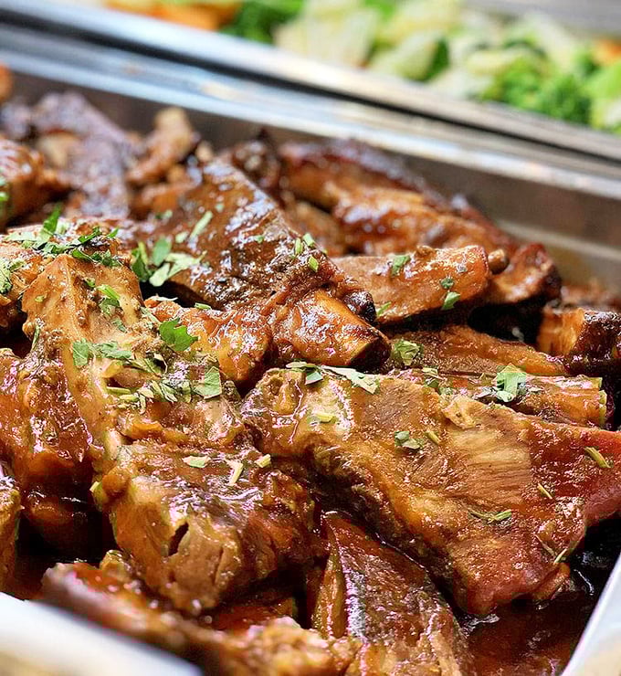 These glistening, herb-flecked ribs aren't just meat—they're edible poetry. Each bite tells a story of slow-cooking mastery that would make any Brazilian grandmother proud.