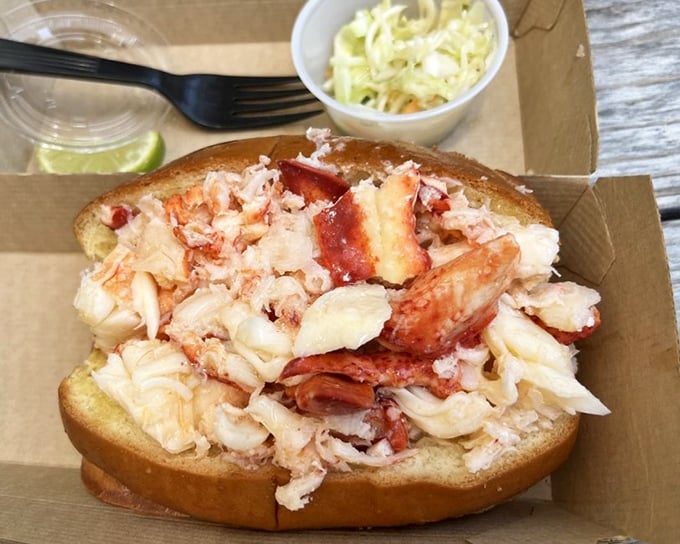 Lobster roll perfection doesn't need fancy presentation—just impossibly fresh meat piled high on buttery bread. The coleslaw sidekick knows it's playing second fiddle to greatness.