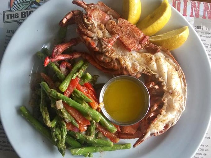 Split lobster perfection with vibrant veggies on the side. This isn't just dinner—it's a crustacean celebration worthy of a bib and a happy dance.