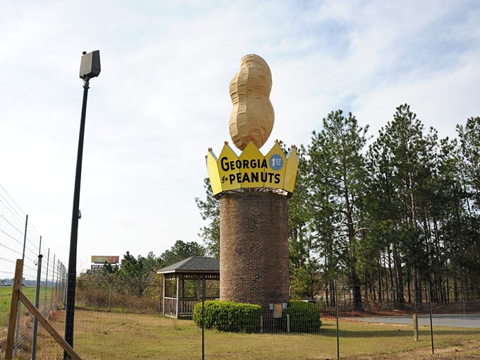 A peaceful park setting surrounds the monument, complete with a gazebo for contemplating life's big questions—like why we build giant peanuts in the first place.