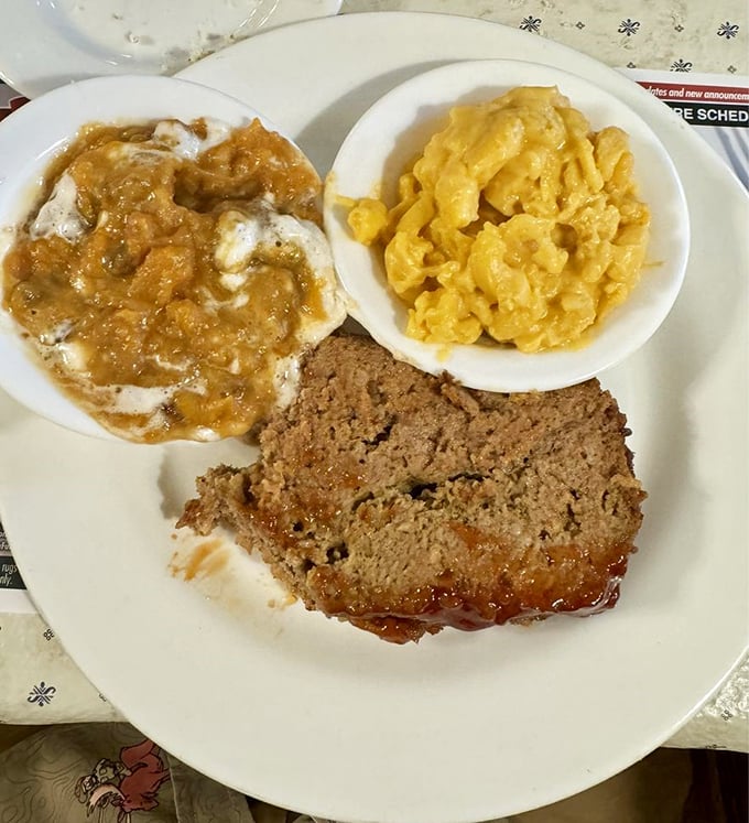 Meatloaf that would make your grandmother both proud and jealous, accompanied by mashed potatoes drowning gloriously in gravy.