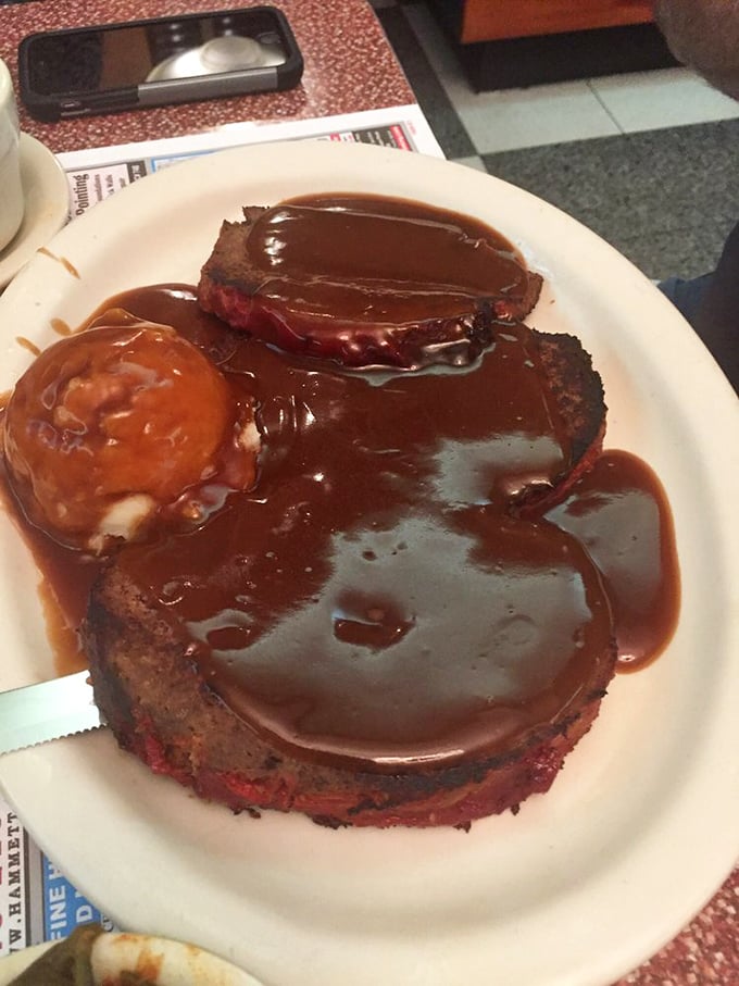 This isn't just meatloaf—it's a brown gravy-bathed monument to comfort food, the kind that makes you want to call your mother and thank her.