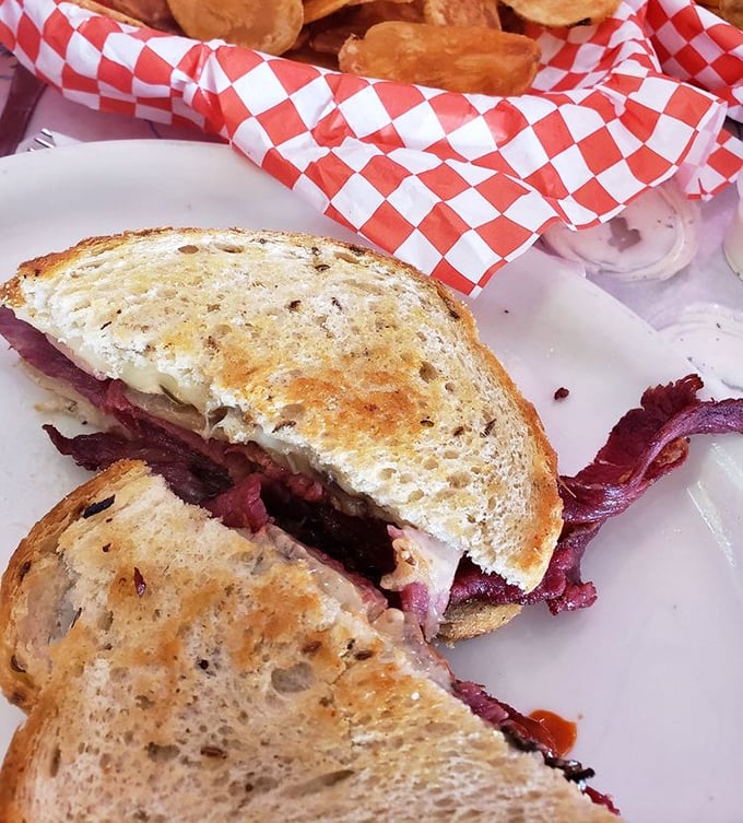 This Reuben sandwich isn't just lunch—it's architecture. Look at those layers of corned beef peeking out like they're trying to escape!