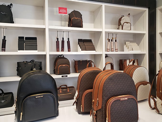 Michael Kors bags lined up like contestants in a beauty pageant, each one whispering, "I'm the same as the downtown store version, just significantly friendlier to your wallet."