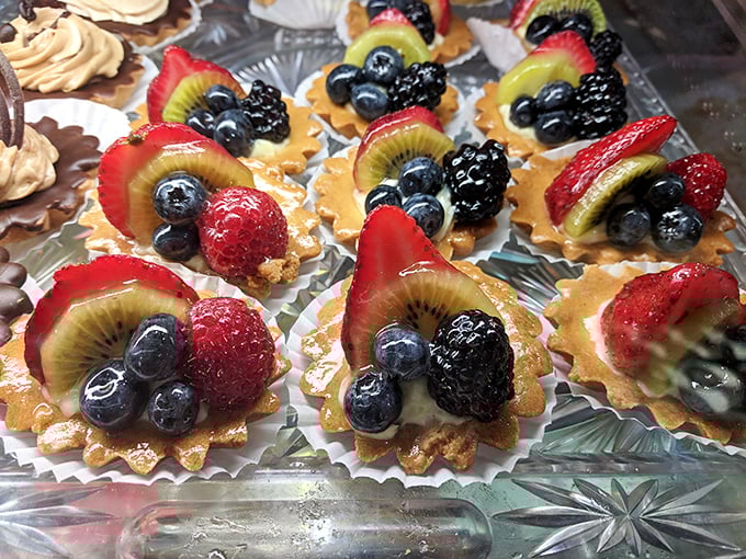 These mini fruit tarts aren't just desserts—they're tiny edible art galleries where berries and kiwi pose atop custard like they're auditioning for a Pixar movie.