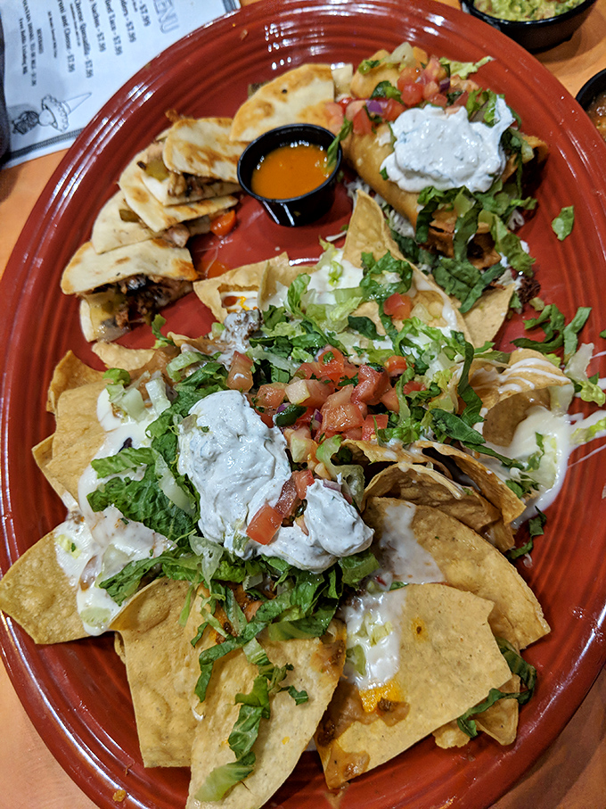 Nacho architecture at its finest! These aren't just chips with toppings—they're a masterclass in proper distribution of cheese, sour cream, and fresh veggies.