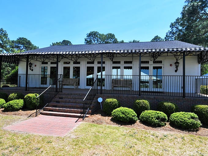 The National Steeplechase Museum's elegant porch invites visitors to sit a spell, proving that Southern hospitality extends even to buildings dedicated to horses running very fast.