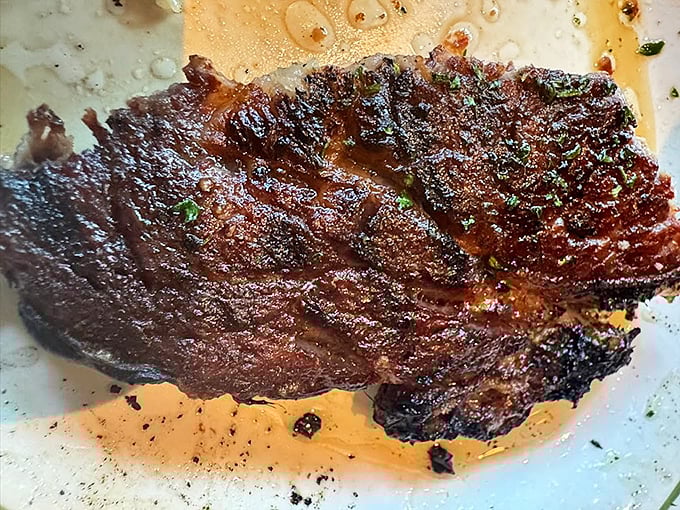 A perfectly seared New York Strip that doesn't need a filter or fancy lighting—just your undivided attention and appreciation.