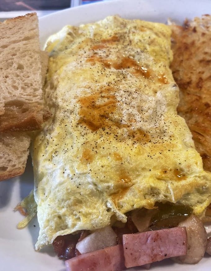 Not all heroes wear capes—some wear perfectly folded egg blankets. This ham and cheese omelet delivers comfort in every golden, peppery bite.