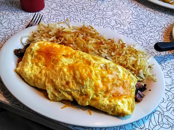 This omelet performs the perfect balancing act—fluffy eggs outside, savory fillings inside, with hash browns that demand respect.