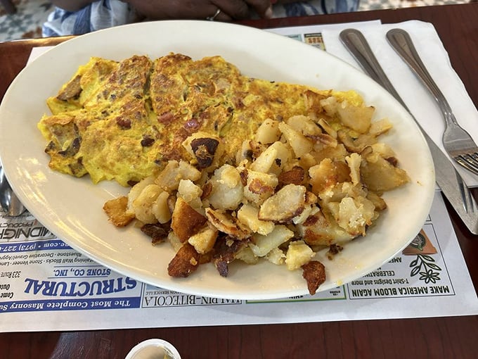 This is what breakfast dreams are made of – a perfectly executed omelet with crispy home fries. The kind of plate that makes you question all other breakfast choices.
