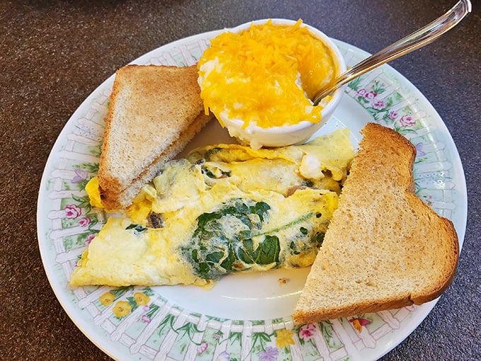 This isn't just any omelet – it's a fluffy canvas of egg perfection, where spinach and cheese unite in breakfast harmony.