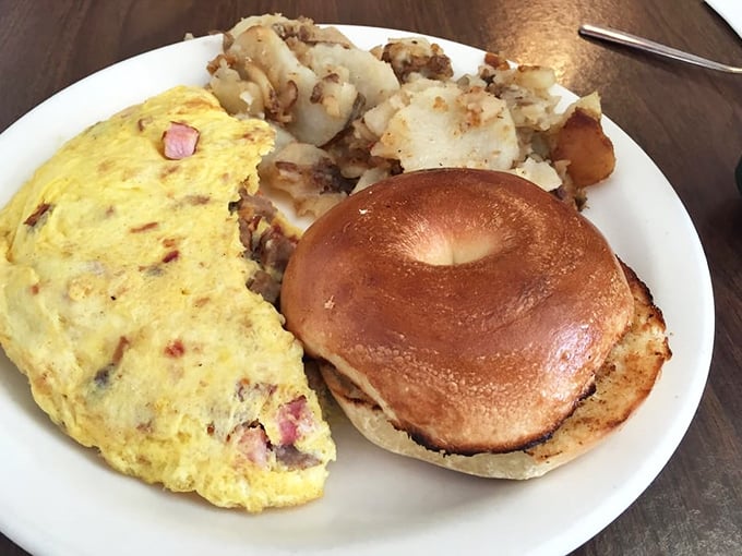This isn't just an omelet – it's a golden envelope delivering a message of ham-filled happiness alongside crispy home fries.