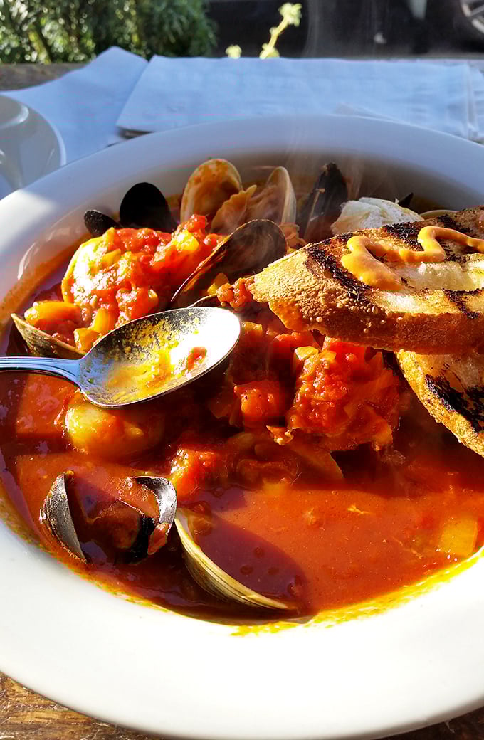 This isn't just seafood stew; it's a maritime celebration in a bowl, complete with clams that practically high-five your taste buds.