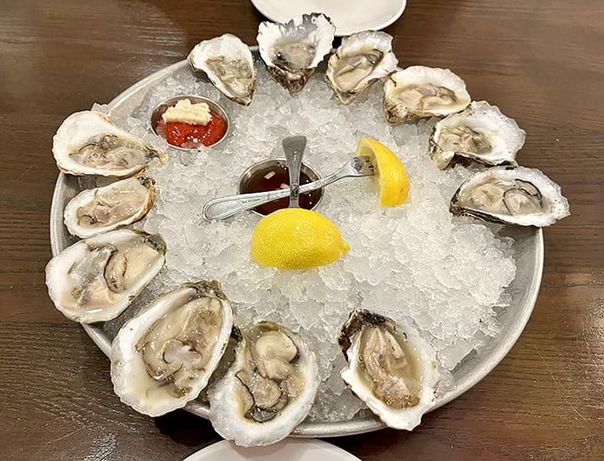 These oysters aren't just served—they're presented like the coastal jewels they are, a perfect circle of briny perfection waiting for a squeeze of lemon.