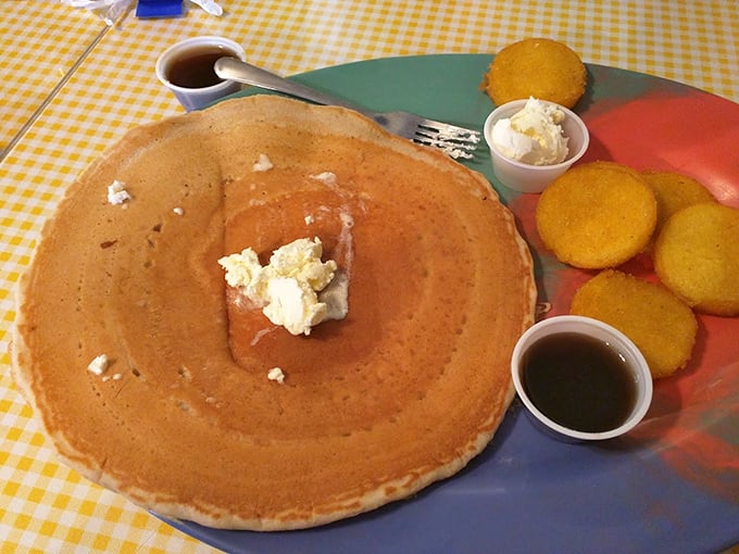 Behold the pancake that launched a thousand breakfast pilgrimages—golden, plate-sized, and waiting for its maple syrup baptism.