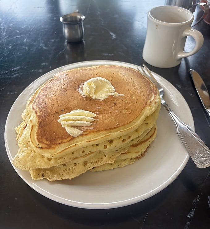 These aren't those sad, flat pancakes that merely transport syrup to your mouth—they're fluffy golden masterpieces with perfect butter-melting pockets.
