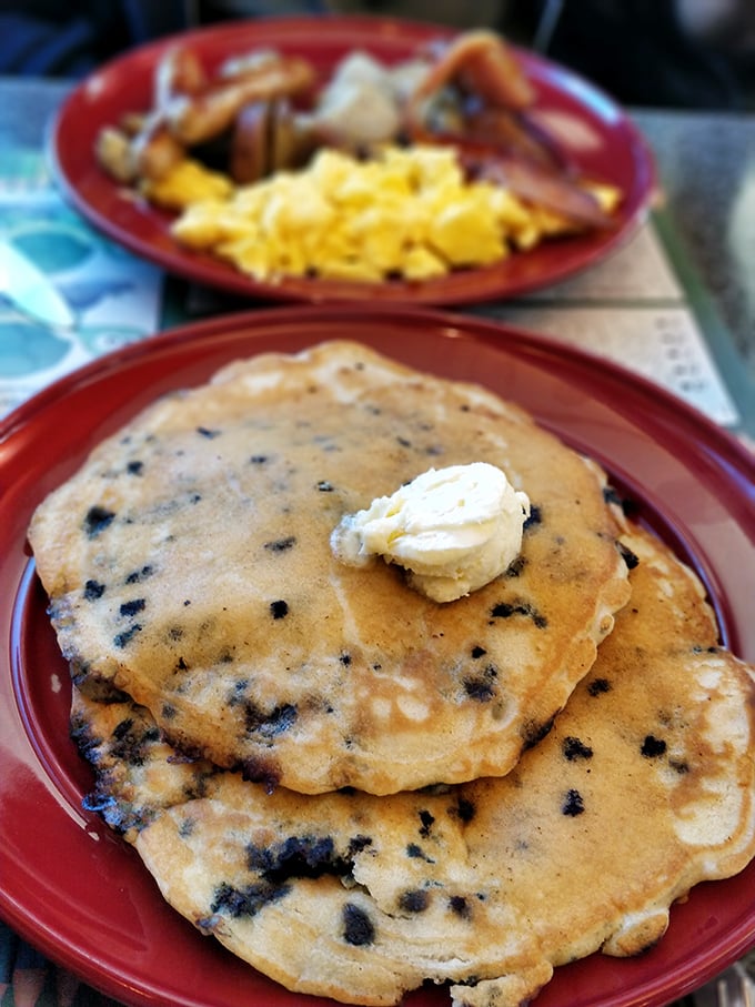 Blueberry pancakes that make you question why anyone bothers with fancy brunch. Those berries aren't just added—they're strategically deployed for maximum flavor impact.
