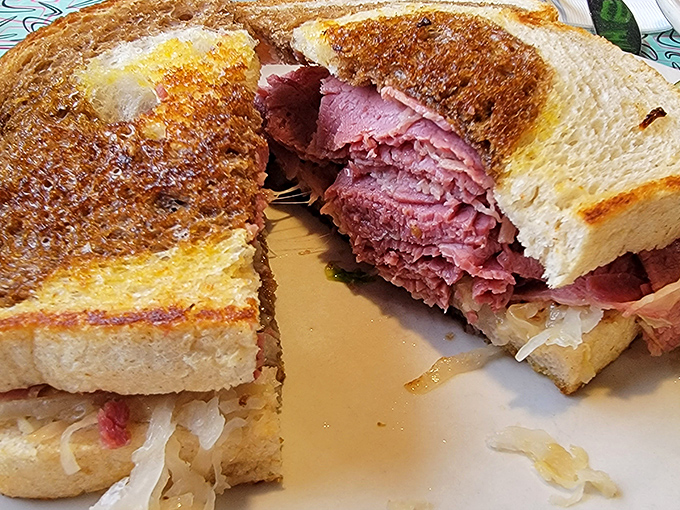 The pastrami doesn't just sit on the bread—it lounges luxuriously, like it's on vacation at a rye bread resort. This sandwich isn't food; it's architecture.