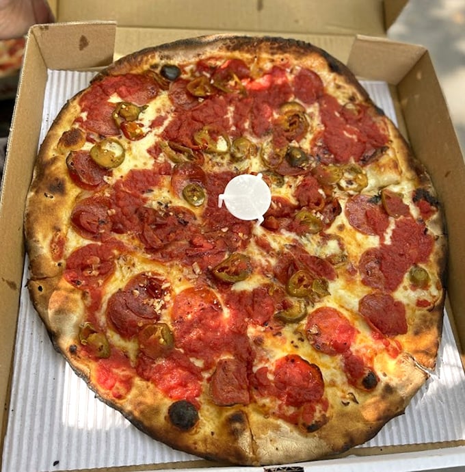 Pizza perfection doesn't need fancy words – just look at that char on the crust and those jalapeños playing hide-and-seek with the pepperoni.