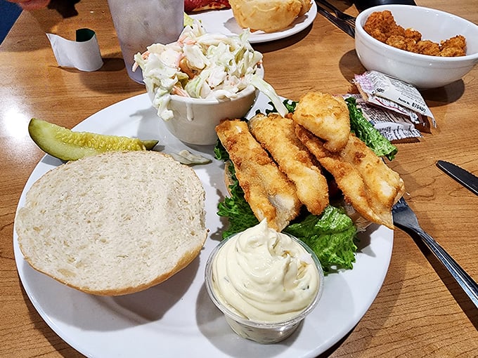 Behold the perch sandwich in its full glory—golden fillets perched atop fresh lettuce with a side of coleslaw that didn't come from a bucket.
