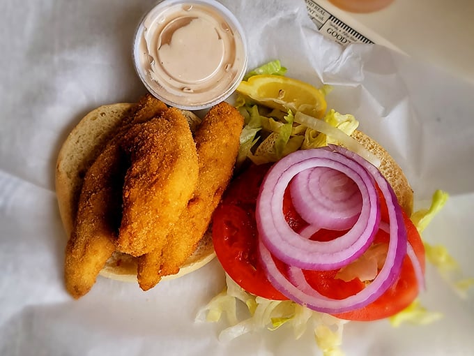 Behold the star attraction: golden-fried Lake Erie perch nestled on a soft bun with crisp veggies. This isn't just lunch; it's Ohio's maritime legacy on a plate.